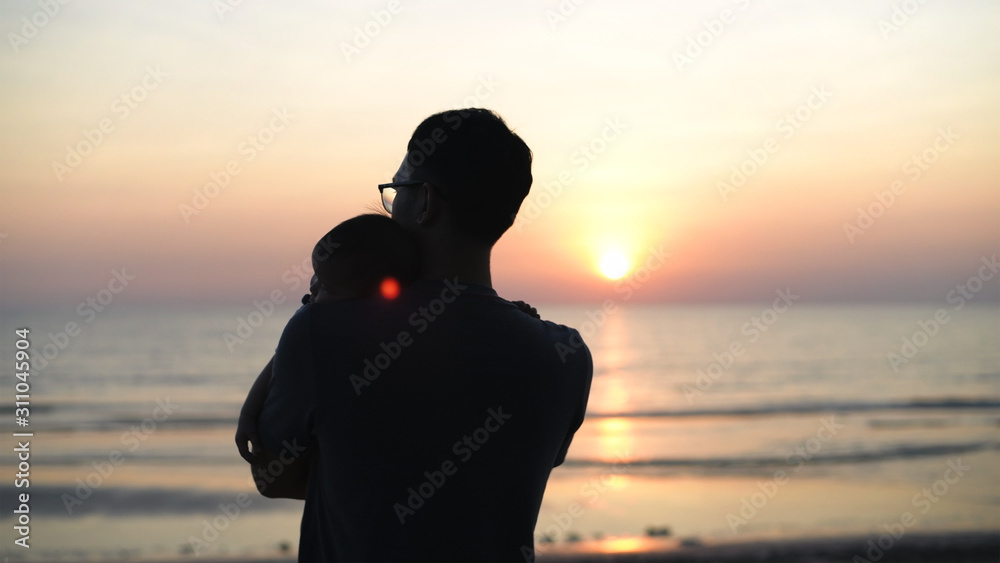Holiday concept. father lulled the baby to sleep on the beach. 4k ...