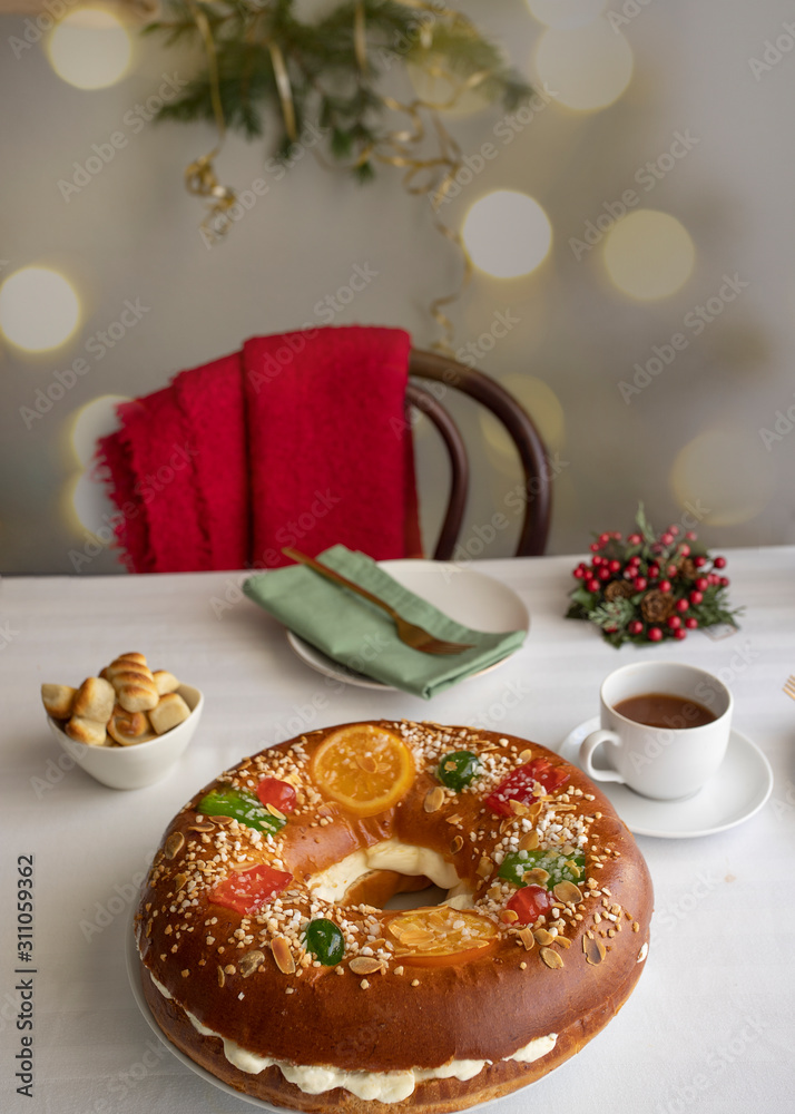 Roscon de reyes , Spanish Christmas cake on the table with traditional ...
