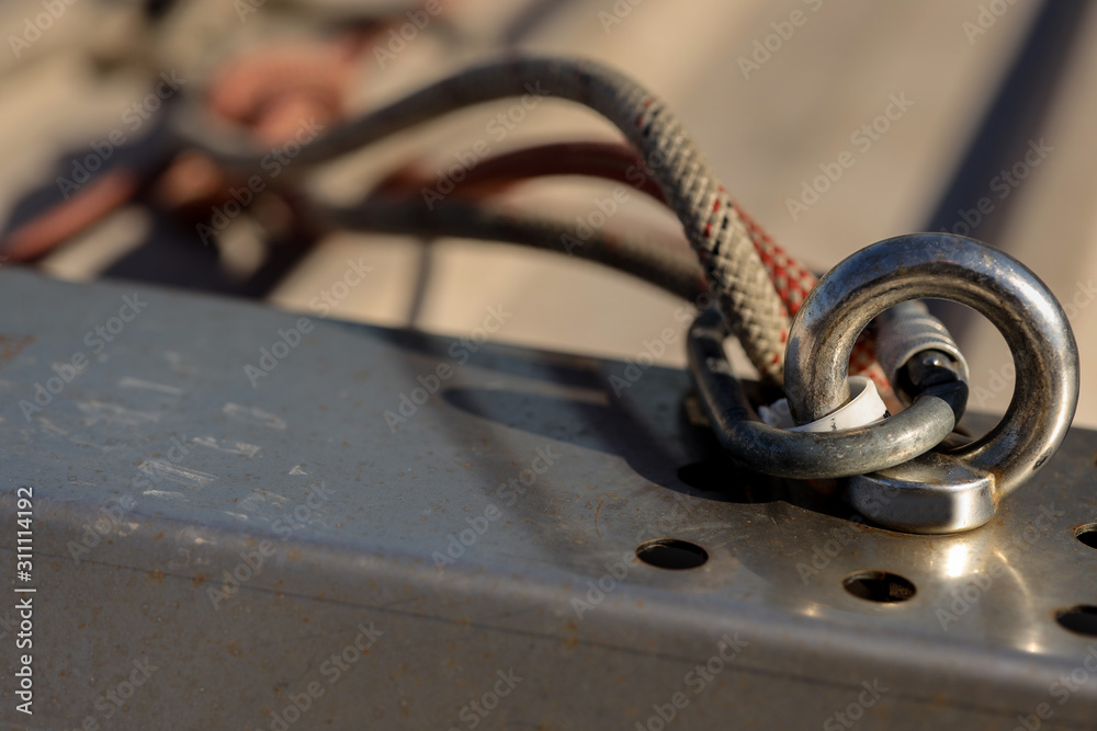 Abseiler construction worker hand clipping locking Carabiner into roof ...