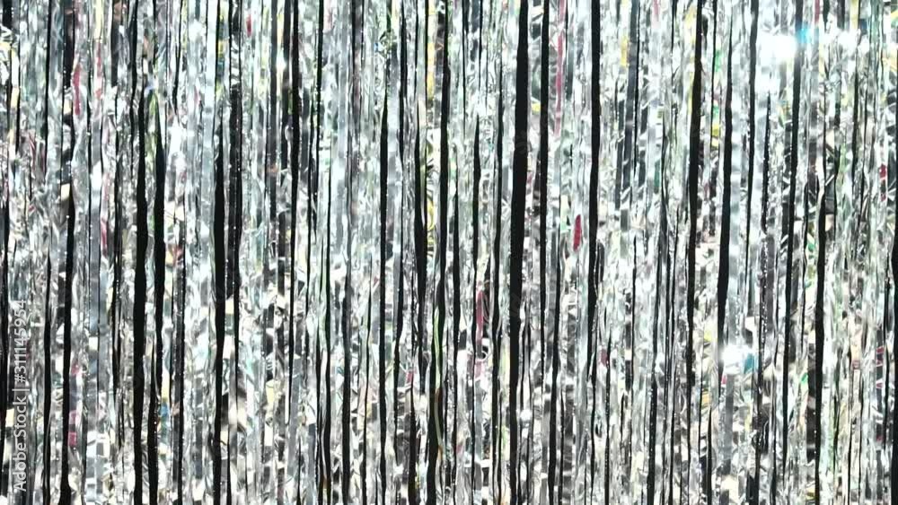Silver rain from tinsel. Dynamic background in shining lights and ...