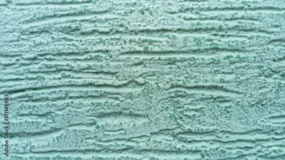 Plastered green wall. The finishing layer is formed by hardened mortar ...