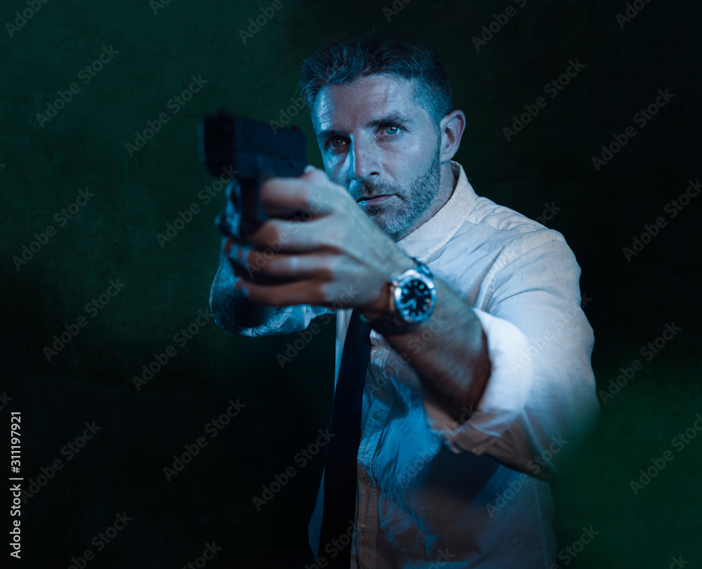 Man pointing handgun - dramatic action portrait of attractive special ...