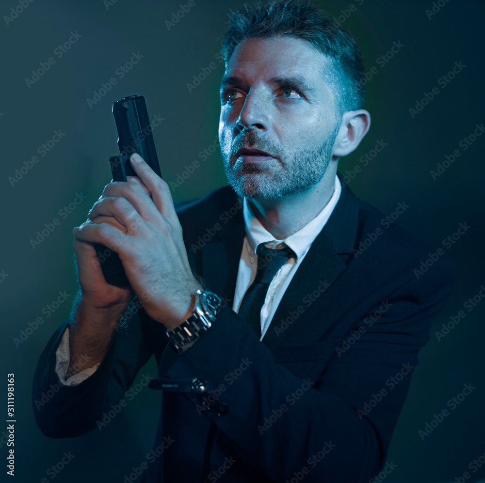 dramatic action portrait of attractive special agent man or police ...
