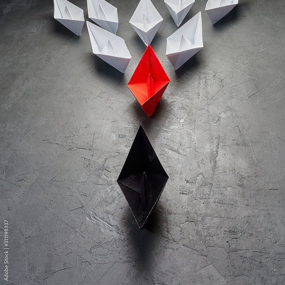 Paper Boat key opinion Leader, influence concept. One black paper boat ...