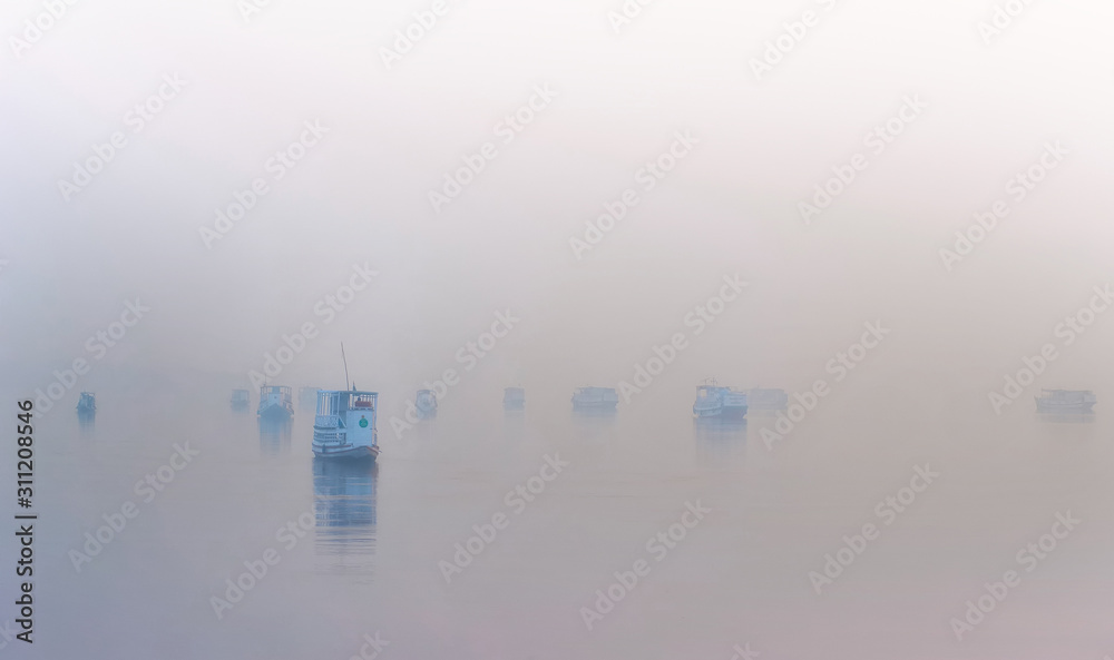 Mist over the bay with houseboats in the Sundarbans National Park ...