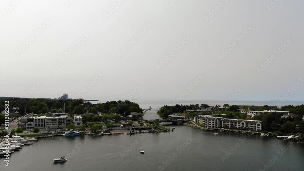 Round Lake in Charlevoix connects to Lake Michigan with boats and sail ...