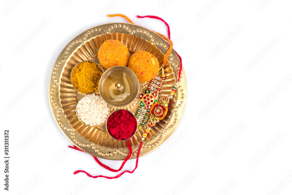 Indian Festival: Rakhi with rice grains, kumkum, sweets and diya on ...