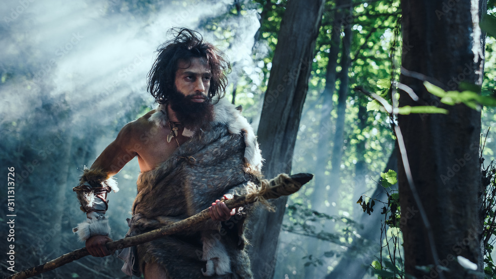 Portrait of Primeval Caveman Wearing Animal Skin and Fur Hunting with a ...