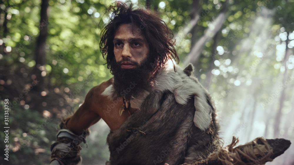 Portrait of Primeval Caveman Wearing Animal Skin and Fur Hunting with a ...