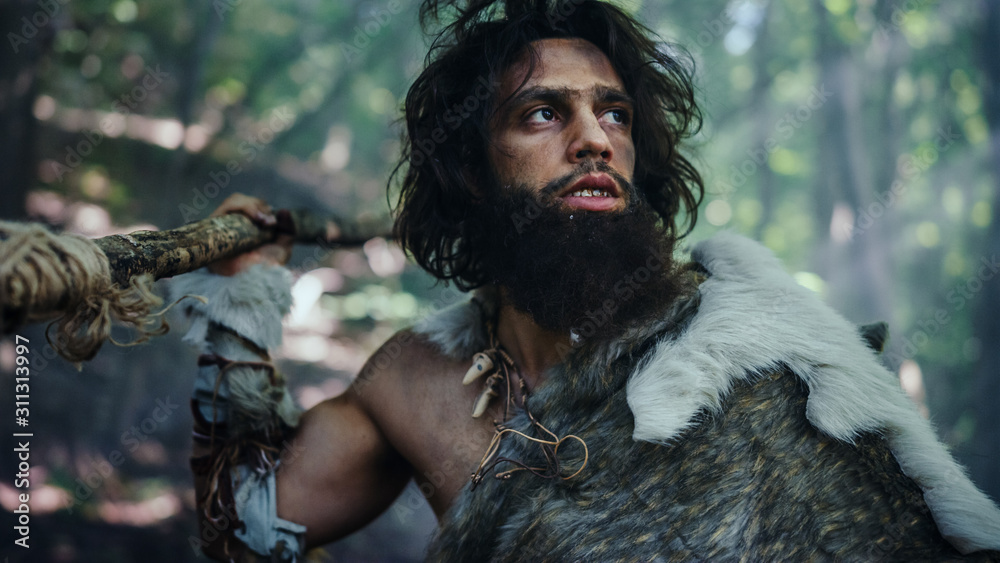 Portrait of Primeval Caveman Wearing Animal Skin and Fur Hunting with a ...