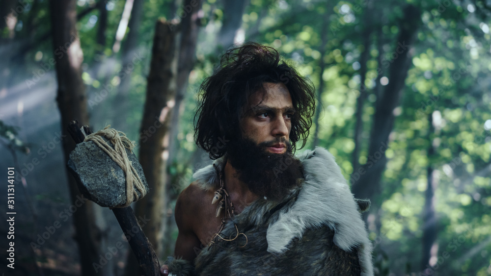 Portrait of Primeval Caveman Wearing Animal Skin and Fur Hunting with a ...