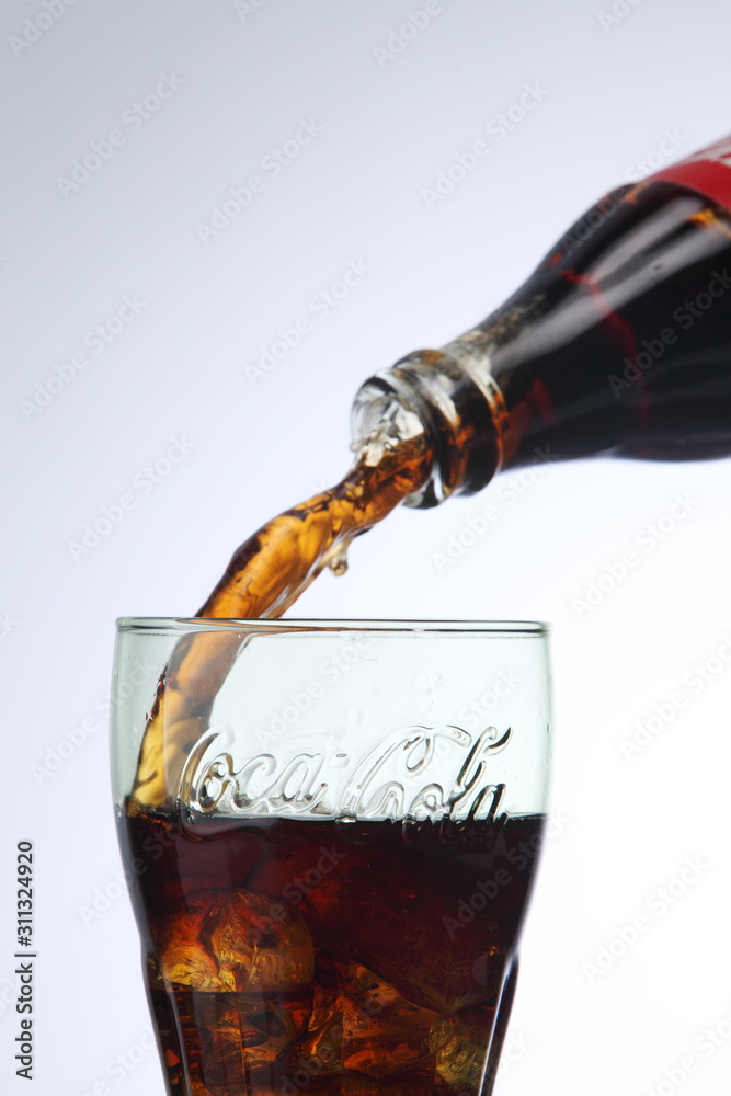 pouring coca cola to coca cola glass with ice cube Stock Photo | Adobe ...