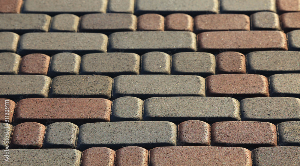 Paving blocks made of new multi-colored stone of regular shape close-up ...