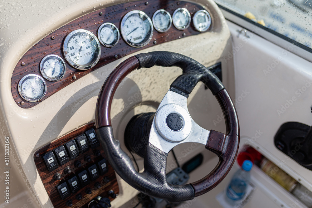 Modern steering wheel on dashboard background of luxury pleasure yacht ...
