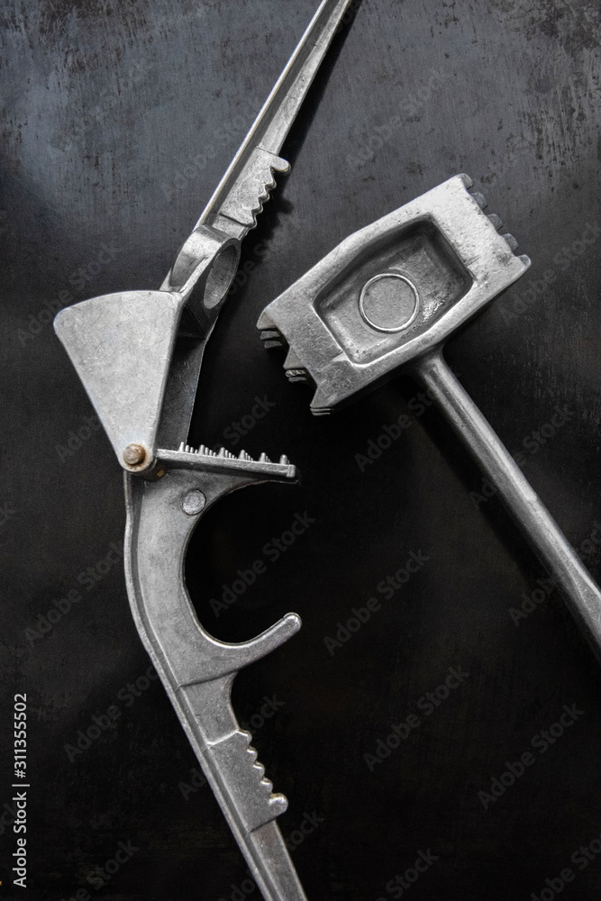 Kitchen utensils decor. garlic press and hammer for beating meat. Metal ...