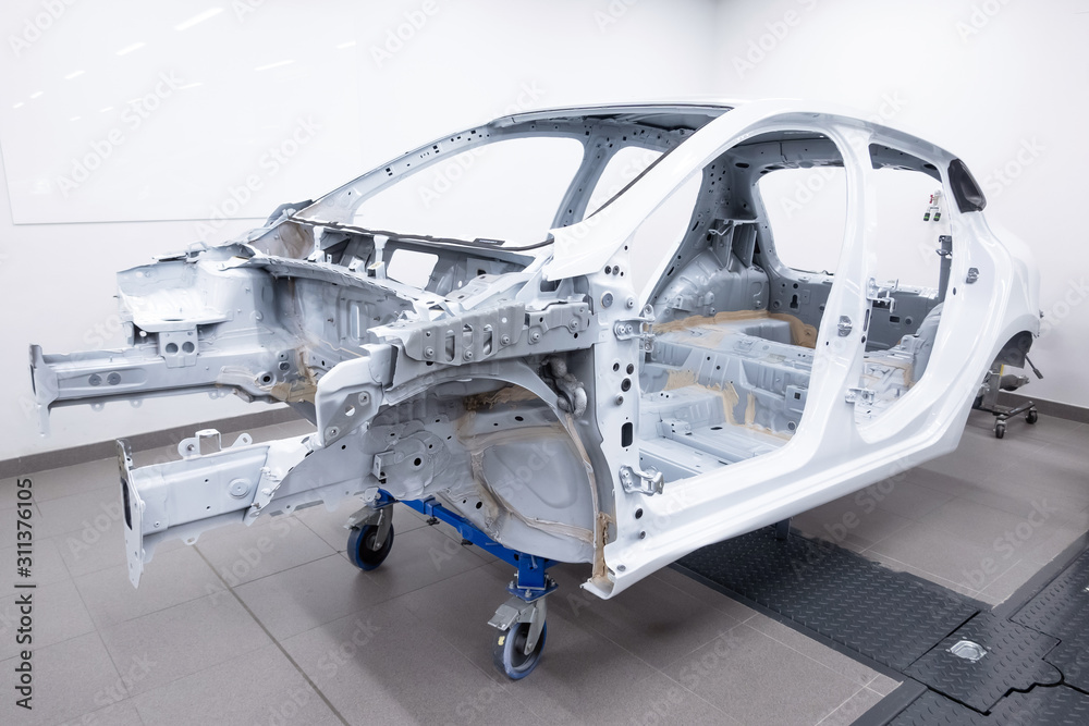 Custom car being build in workshop. Sports car body, car frame is ...
