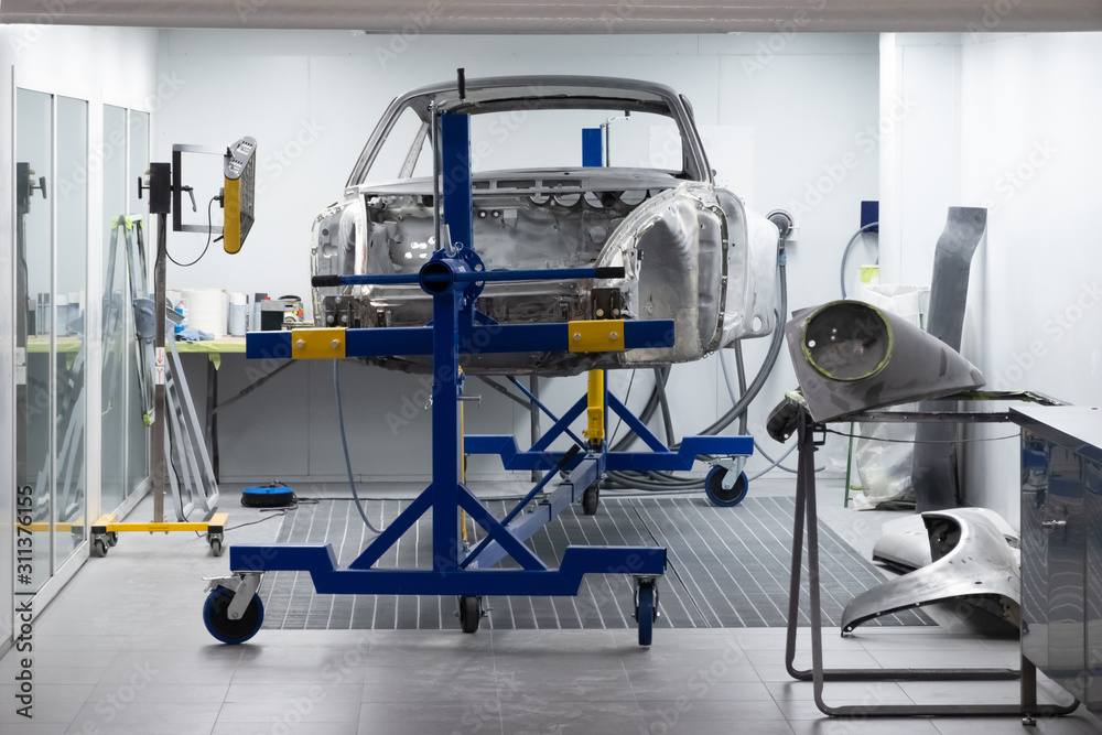 Custom car being build in workshop. Sports car body, car frame is ...