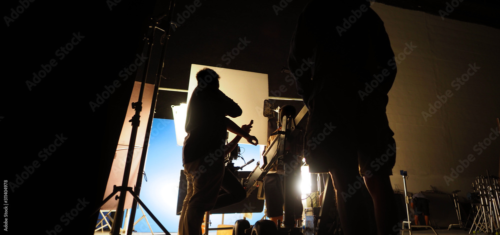 Behind the scenes of video or movie production in big studio and blue ...