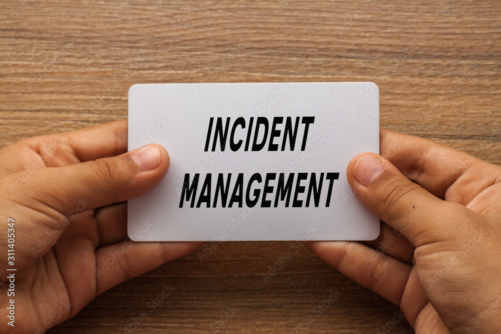 Incident Management written on white card holding with two hands Stock ...
