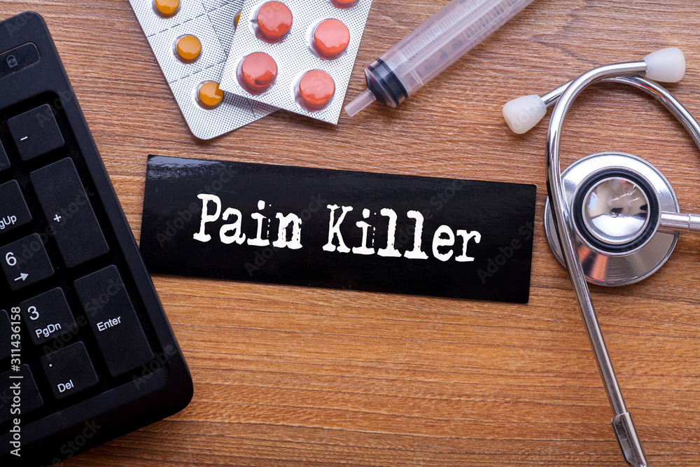 Pain Killer words written on label tag with medicine,syringe,keyboard ...