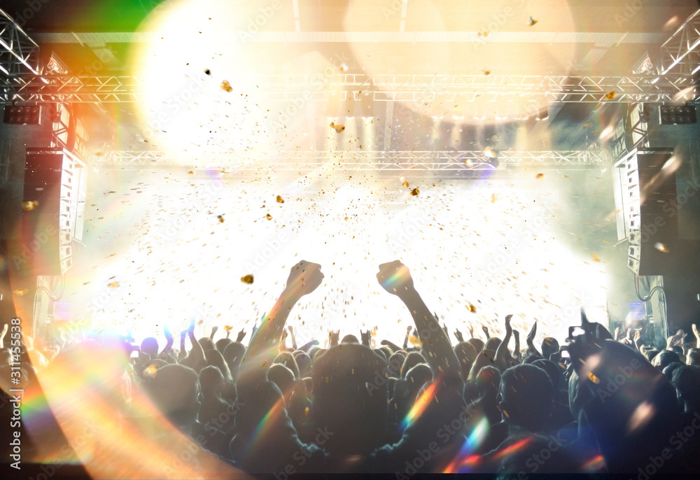 Colorful concert hall crowded with fans attending and clapping a gig ...