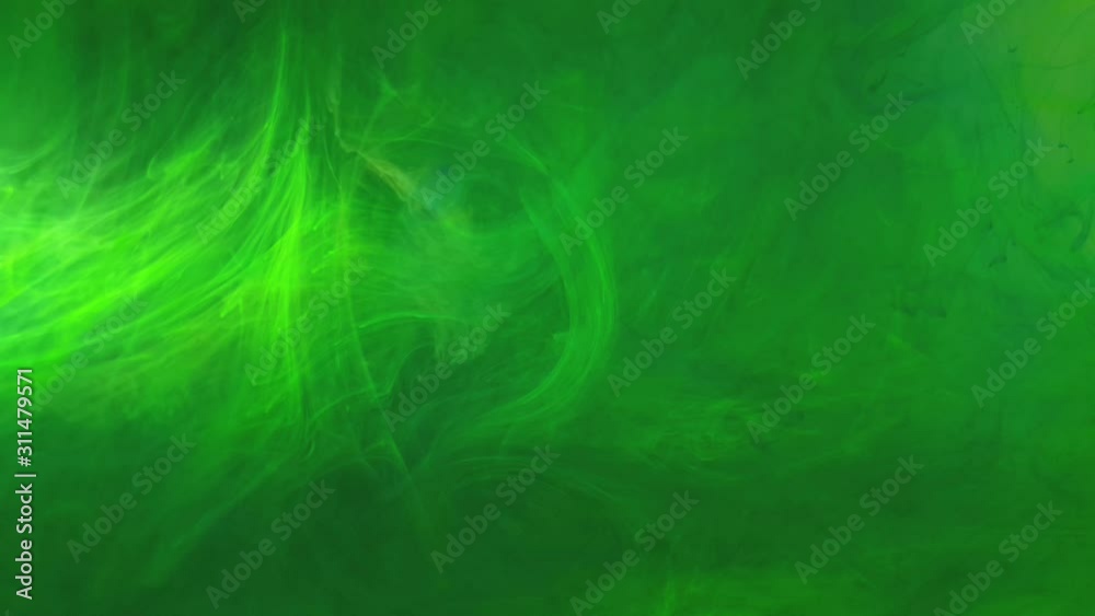 saturated emerald and lime green color acrylic ink flowing and swirling ...