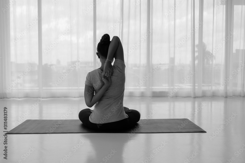 female doing stretching exercises yoga practice. Hands behind back ...