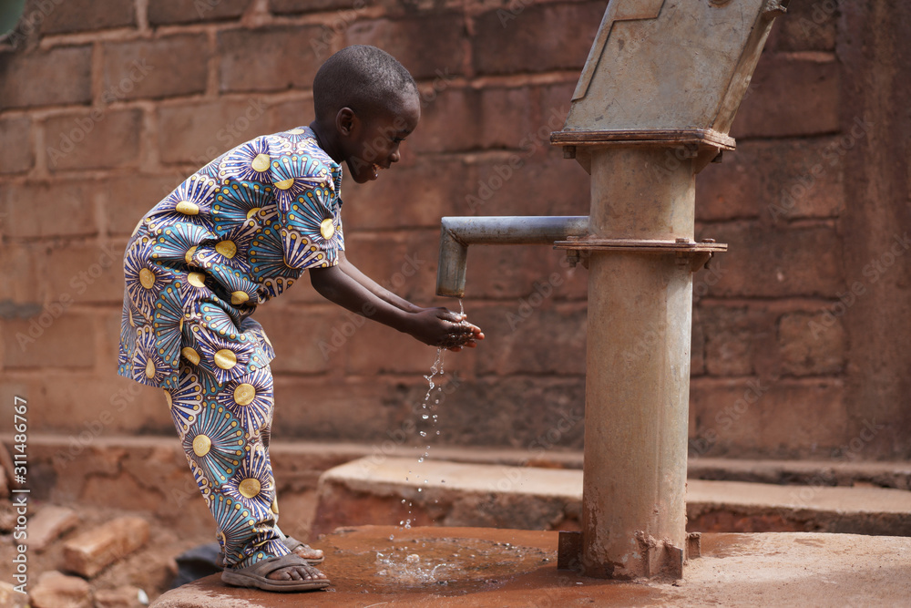 Happy Little African Boy Washing His Hands At the Village Pump Stock ...