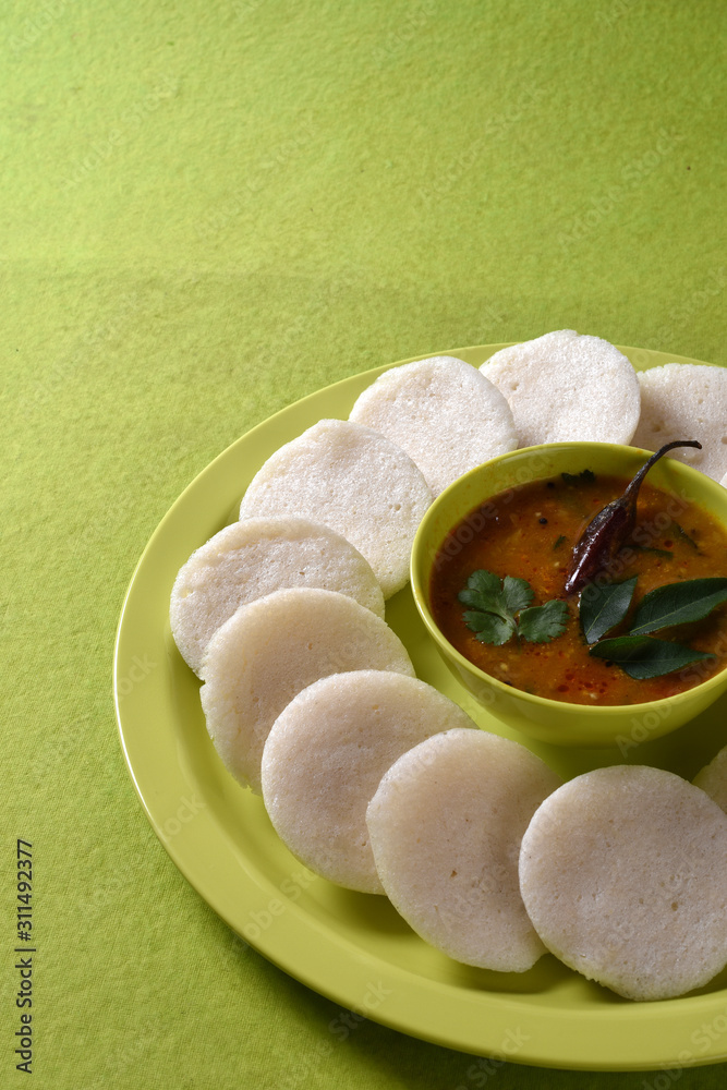 Idli with Sambar in bowl on green background, Indian Dish : south ...