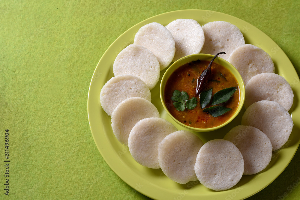 Idli with Sambar in bowl on green background, Indian Dish : south ...