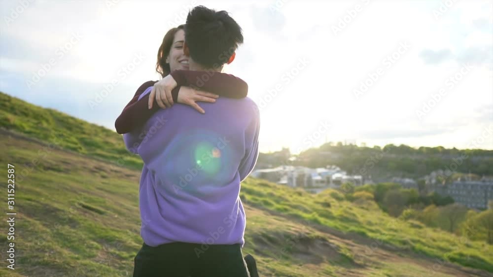 Young Couple Spinning Around While Hugging And Kissing Passionately on ...