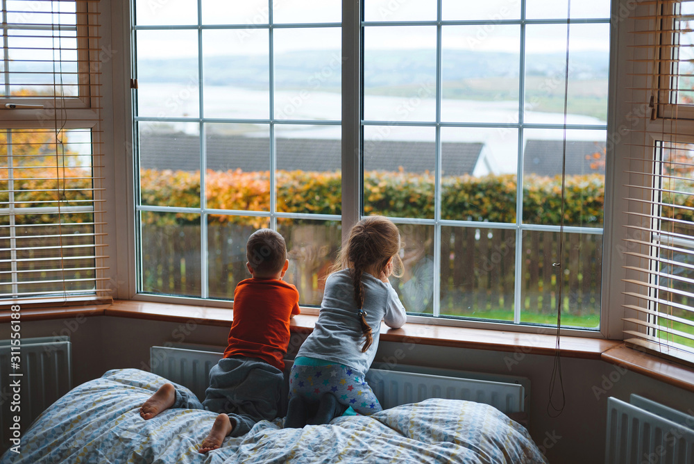 children looking through window Stock Photo | Adobe Stock