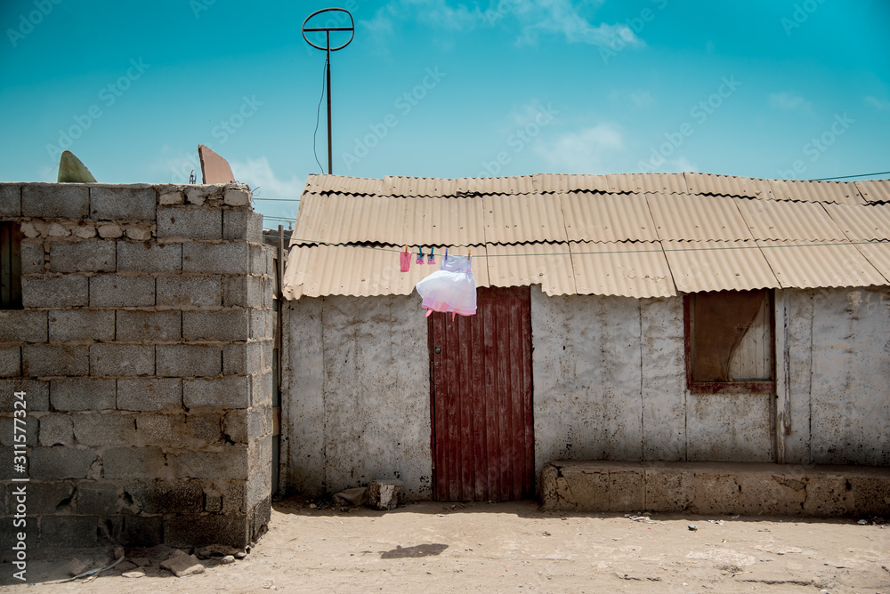 Building work in african slum. white washed little baby girl dress ...