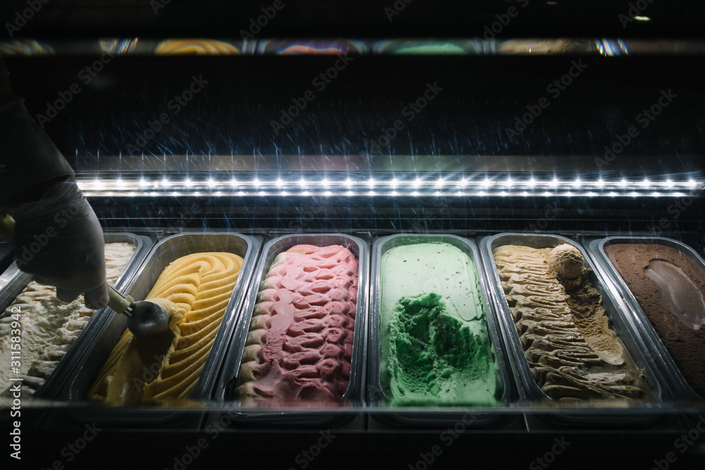 ice cream in a candy store. pistachio, chocolate, strawberry, banana ...