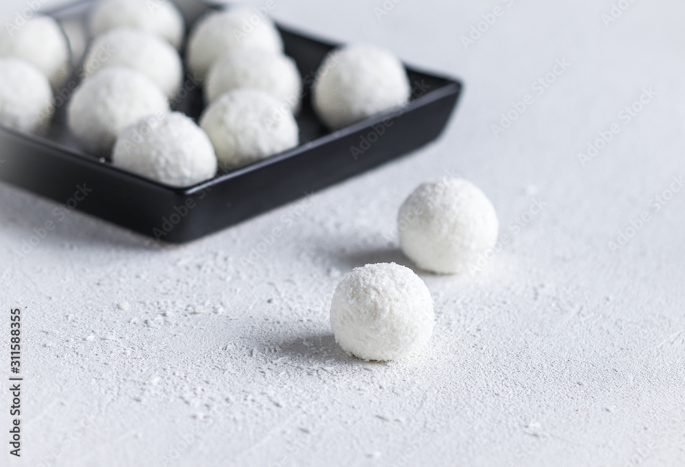 essert curd balls in coconut shavings on a light white background Stock ...