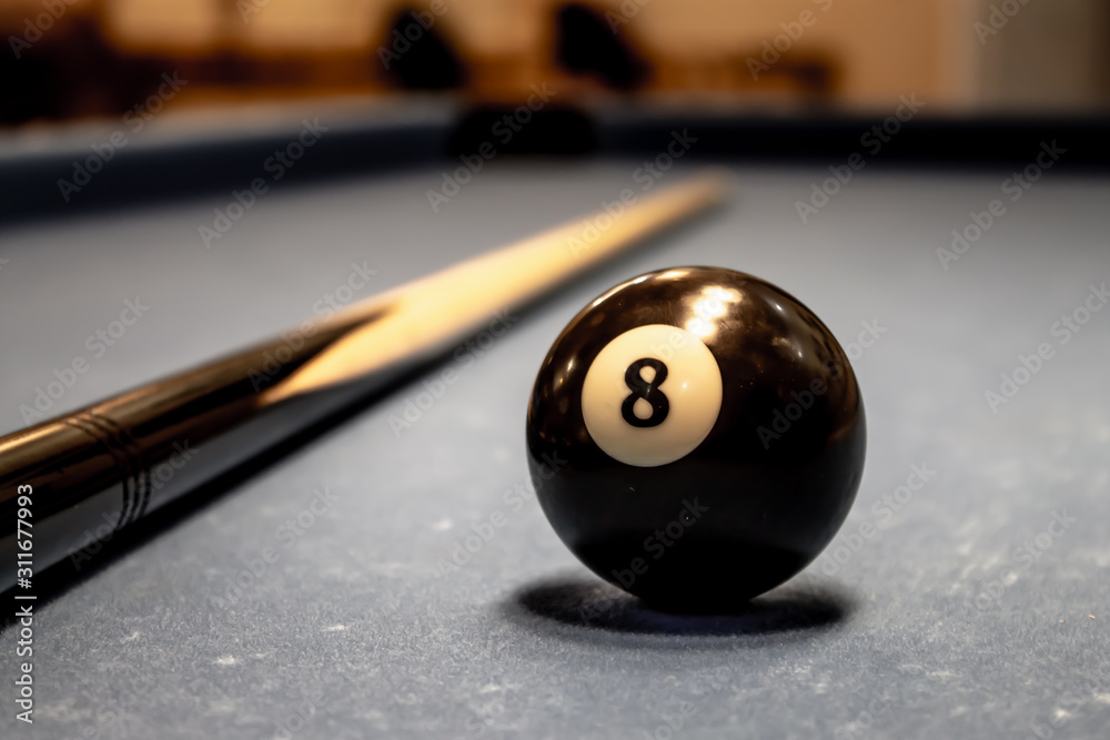 Billiard ball figure eight on a table with cues. Stock Photo | Adobe Stock