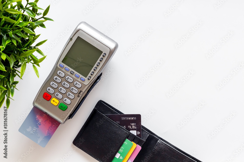 Pay by credit card in shop. Terminal and card on white background top ...