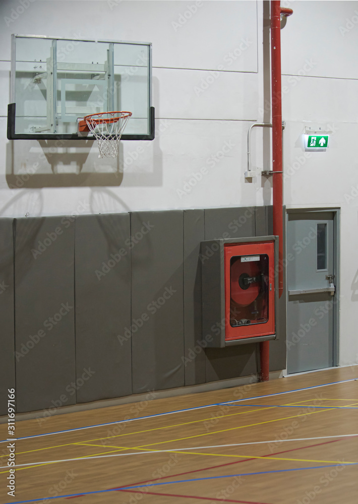 Interior of a sport pavilion, seeing an emergency exit door with an ...