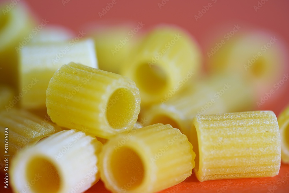 Macro view on uncooked traditional Italian pasta tubes ditaloni rigati ...