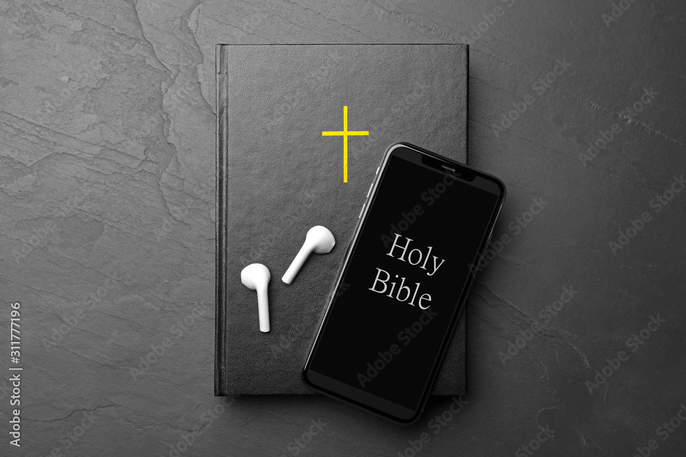 Bible, phone and earphones on black background, top view. Religious ...