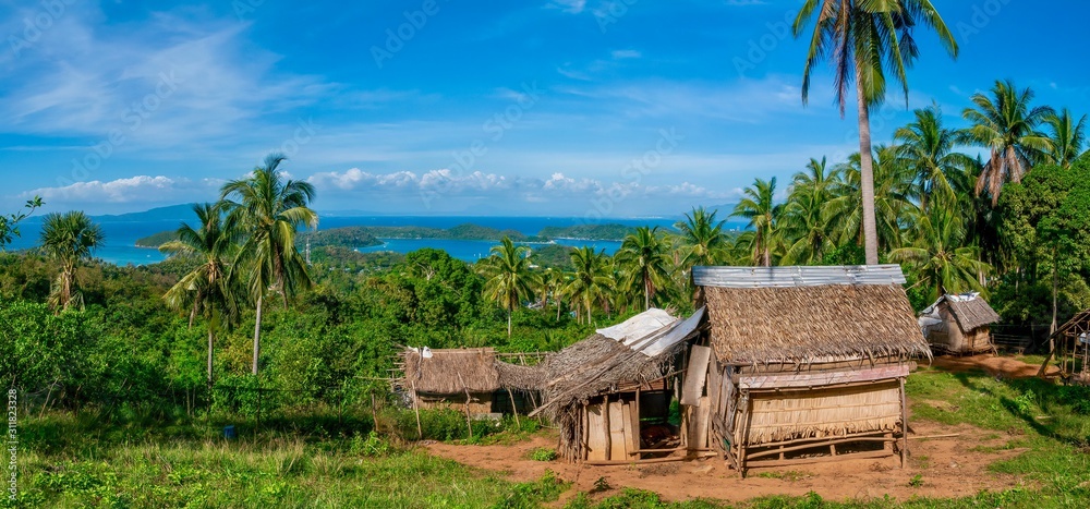 A small village on a beautiful tropical island, with traditional ...