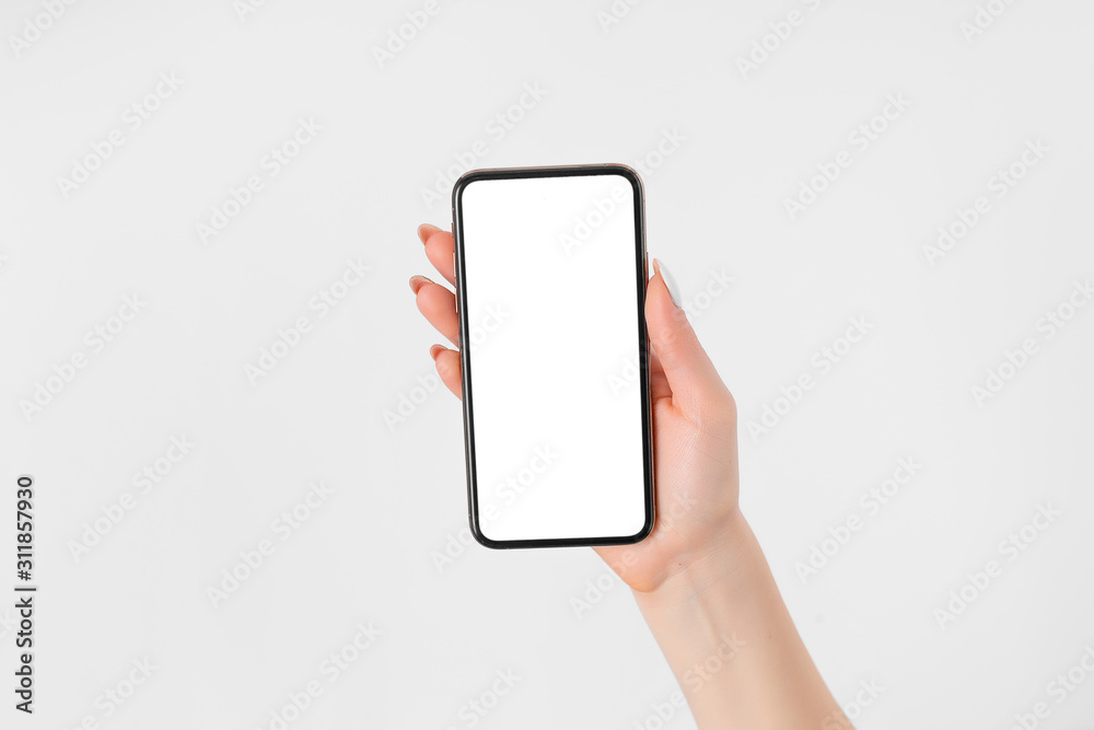 Female hand holding and touching on mobile smartphone with white screen ...