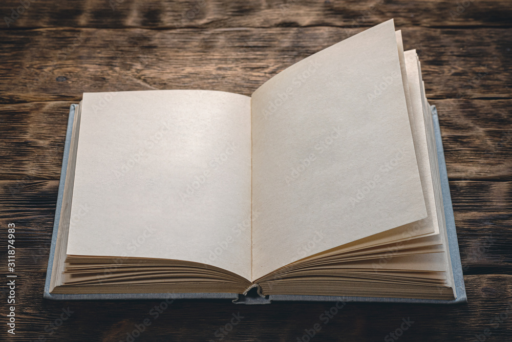 Blank page open book with copy space on brown wooden desk background ...