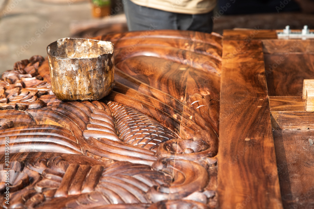 beautiful carved woodwork in an Indian street workshop. The hands of an ...