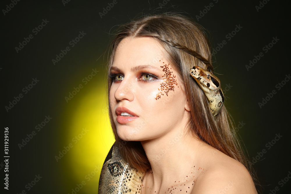 Beautiful woman with boa constrictor on color background Stock Photo ...