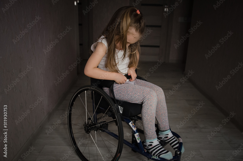 Beautiful sad girl child disabled child sitting in a wheelchair ...
