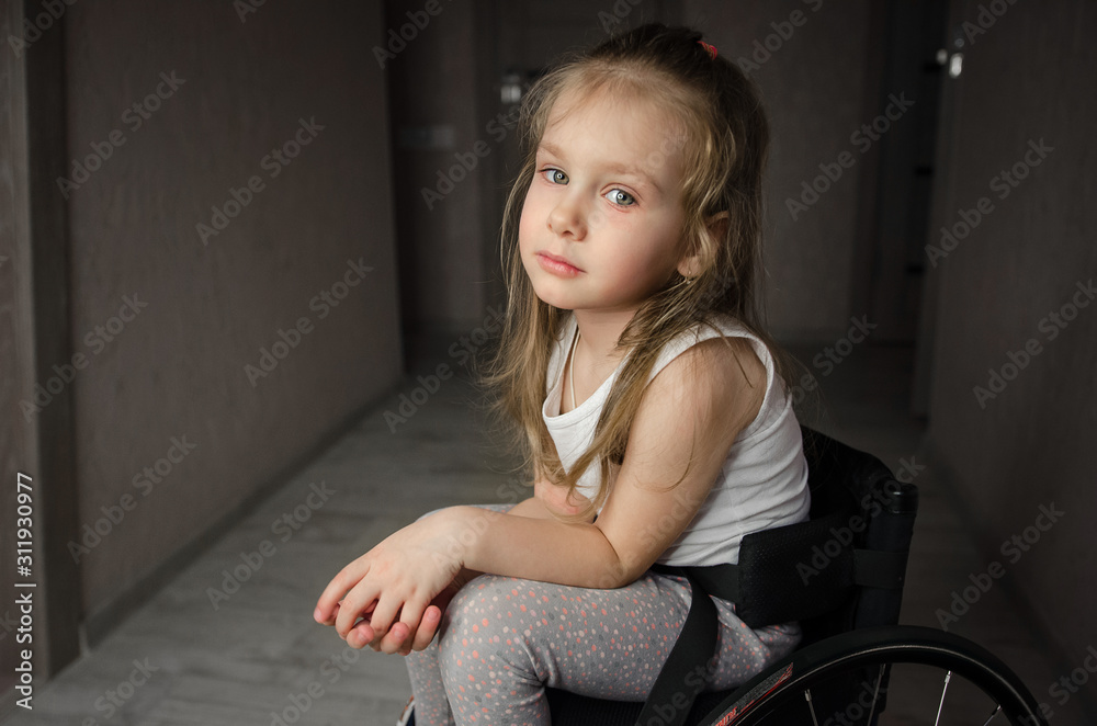 Beautiful sad girl child disabled child sitting in a wheelchair ...
