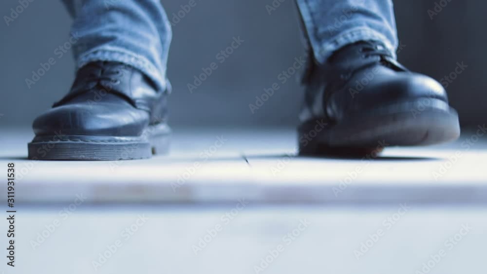 Professional step dance close up. The dancer taps the rhythm with his ...
