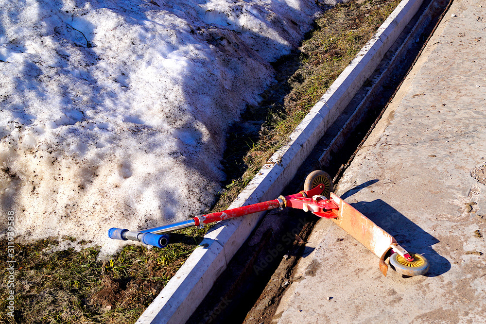 Old red rusty abandoned scooter lying on the concrete floor. Stock ...