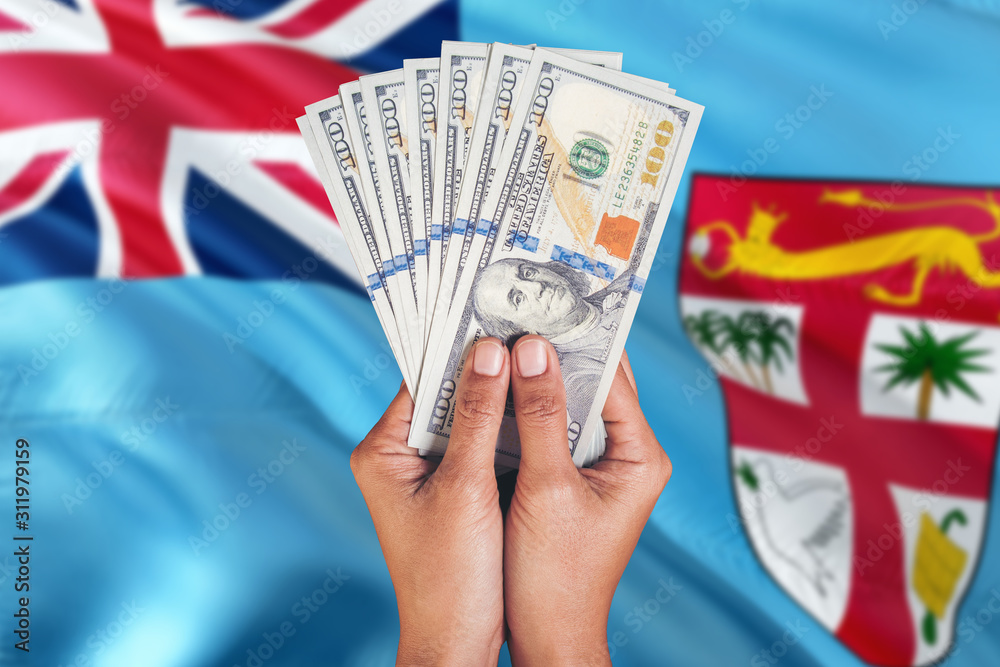 Fiji financial concept. Female hand holding dollar banknotes on ...